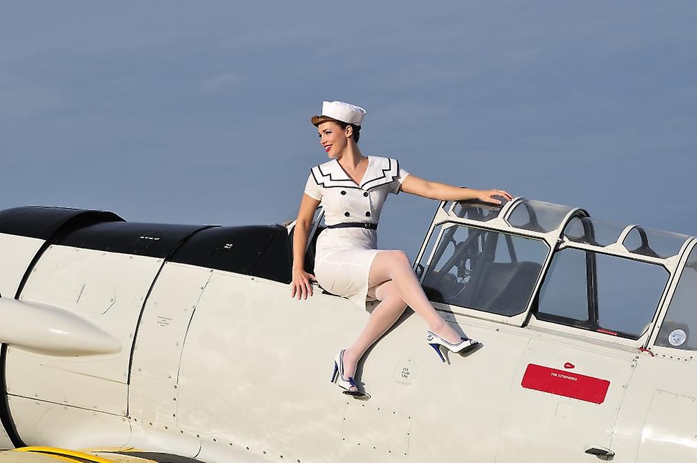 1940's style pin-up girl sitting outside the cockpit of a T-6 Texan ...