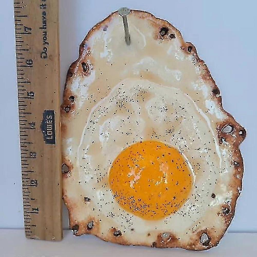 Fried Egg Hanging On A Nail, Decorated With Egg Sculptures Thrown On ...