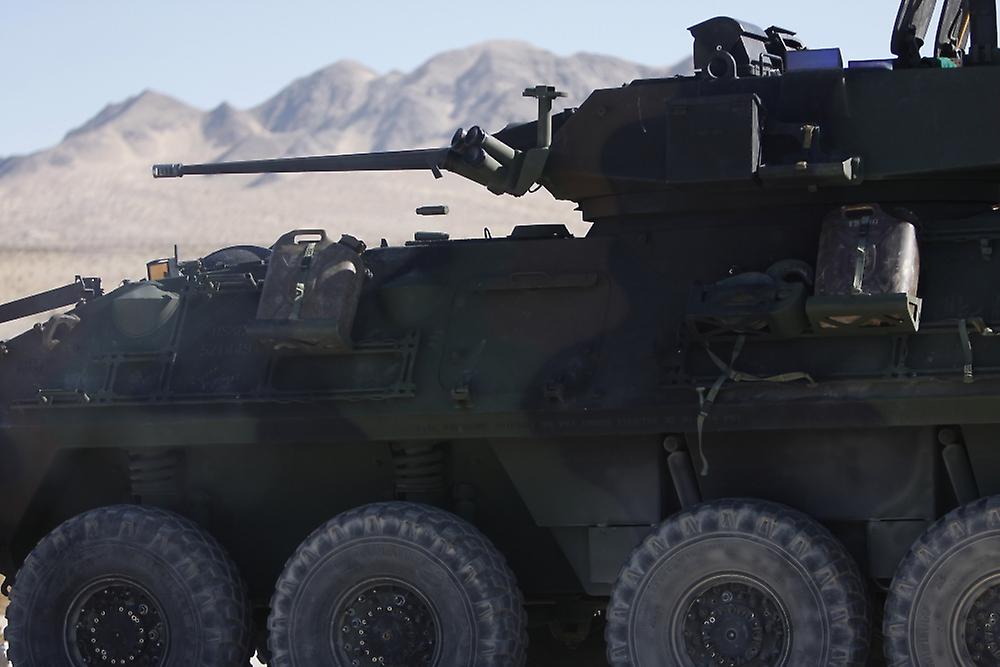 A light armored vehicle fires its 25mm Bushmaster chain gun. Poster ...