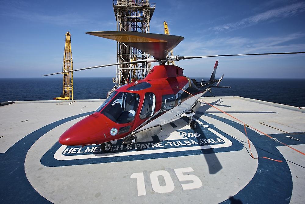 AgustaWestland AW109E utility helicopter on the helipad of an oil rig ...